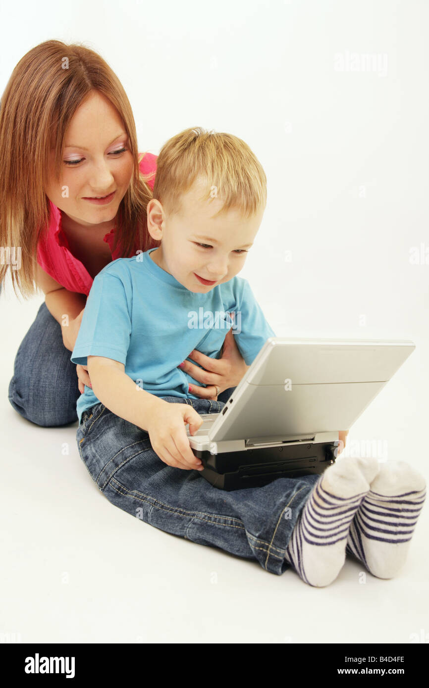 Mother and two year old boy watching a DVD together on a portable DVD ...