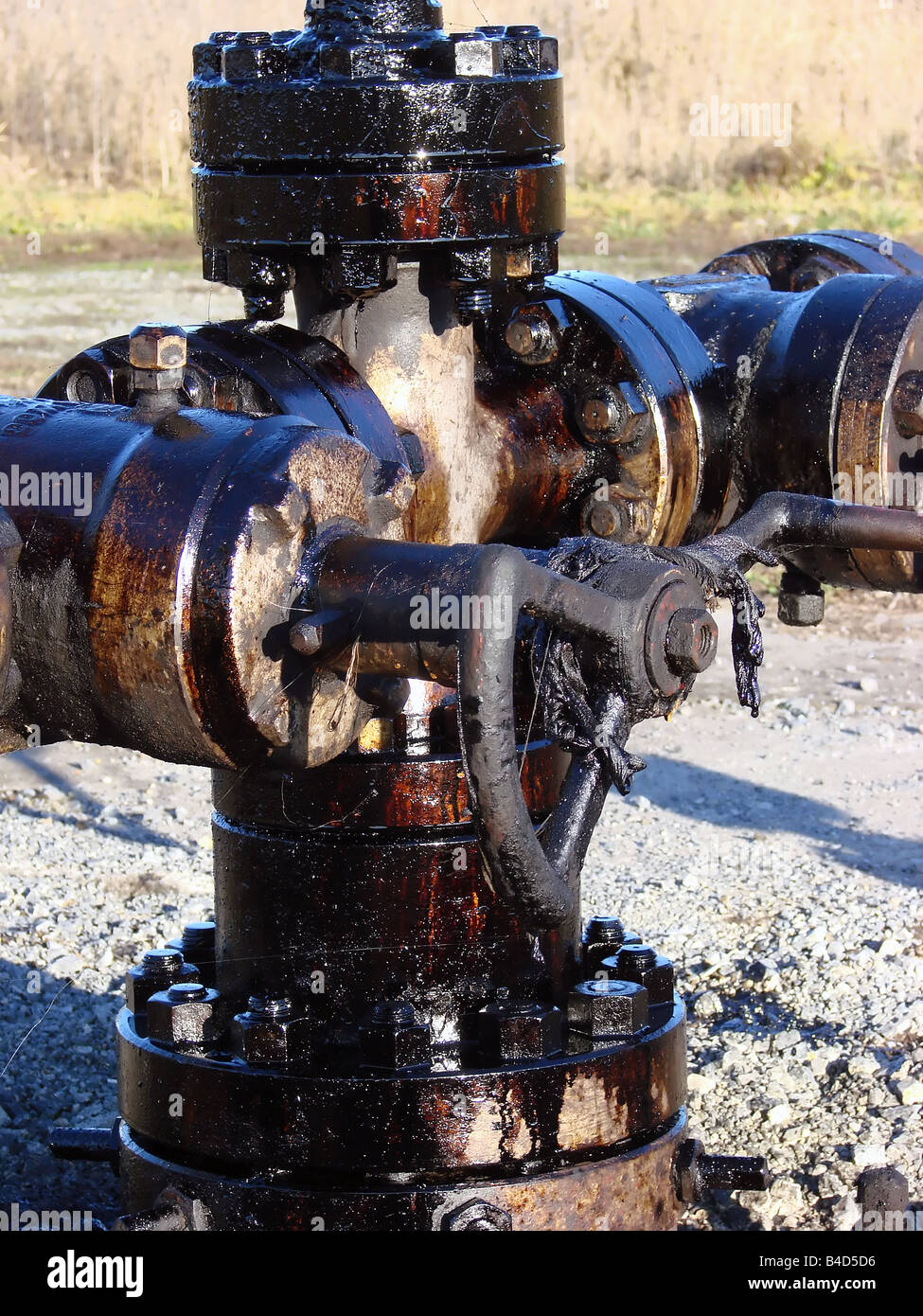 Greasy oil pumpjack drill hole pipe Stock Photo - Alamy