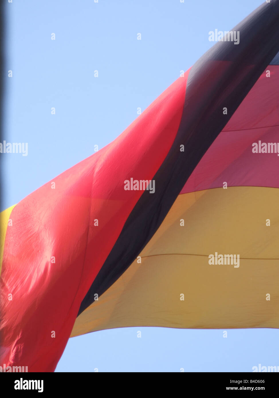 german flag flying in blue sky in berlin Stock Photo - Alamy