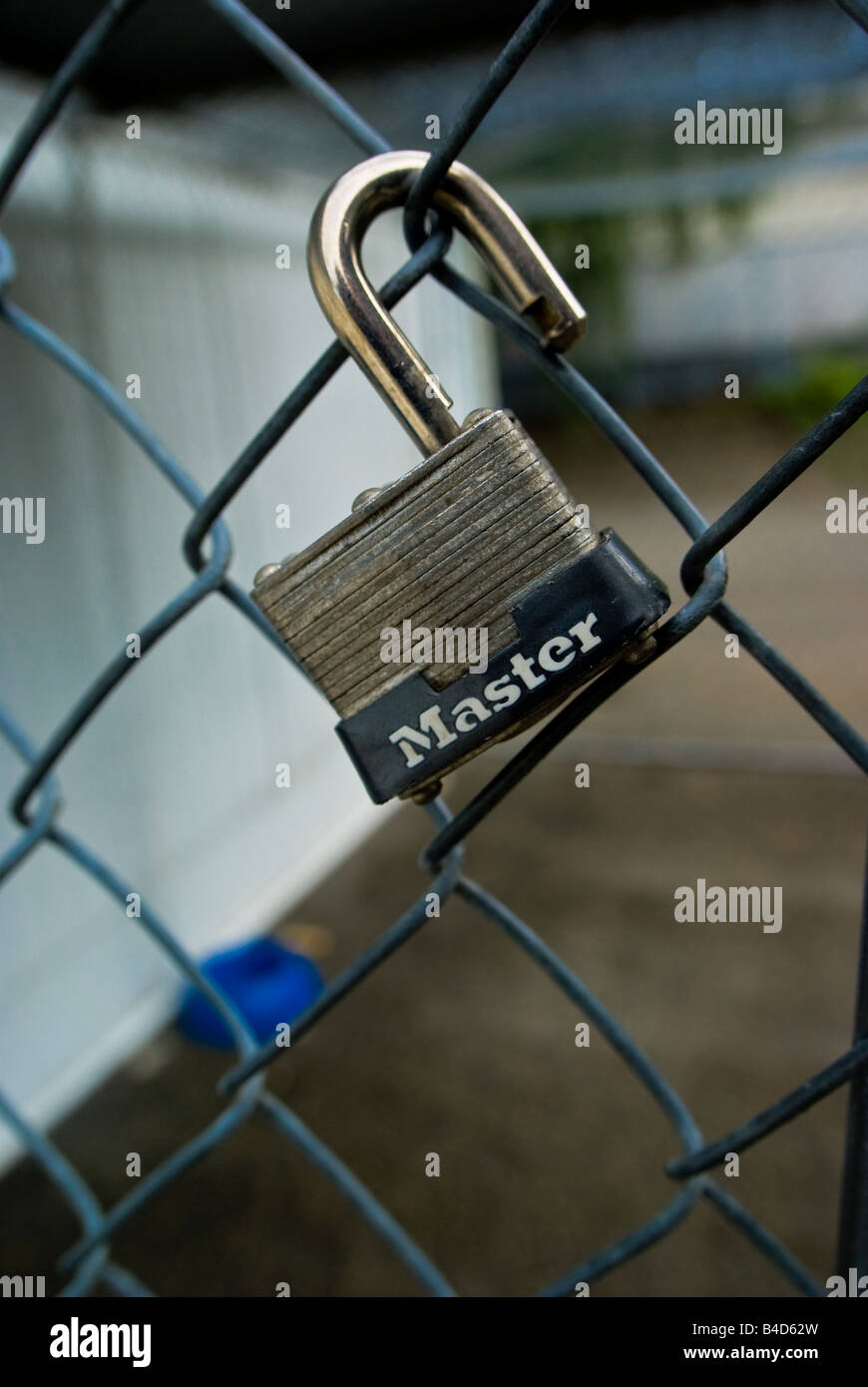 An open padlock hanging on the door of the outside stray hold area of a ...