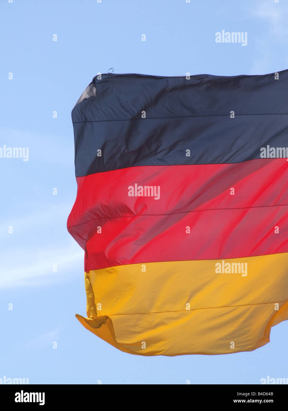 german flag flying in blue sky in berlin Stock Photo - Alamy