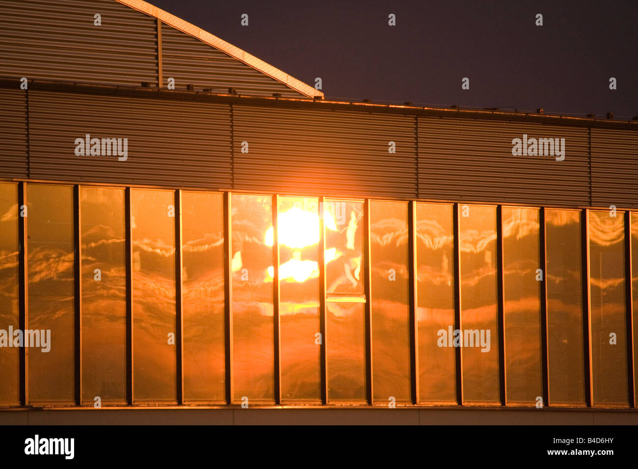 Factory on the outskirts of Kosching with the sunset reflecting in its ...
