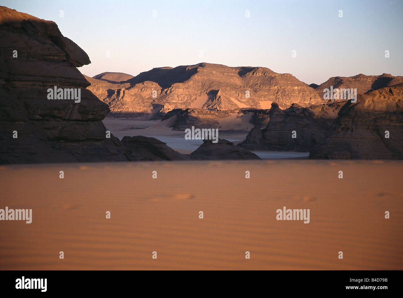 Sand dunes and rocky mountains at Jebel Acacus, Sahara Desert, Libya ...