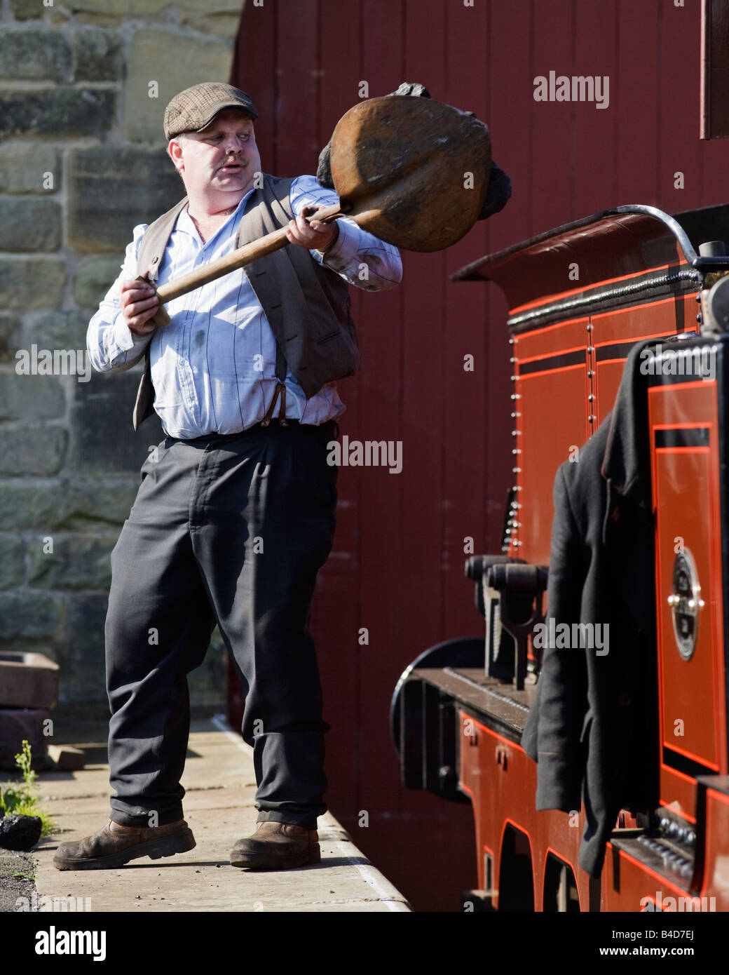 Stoker filling a steam engine tender with coal at the Beamish Open Air ...