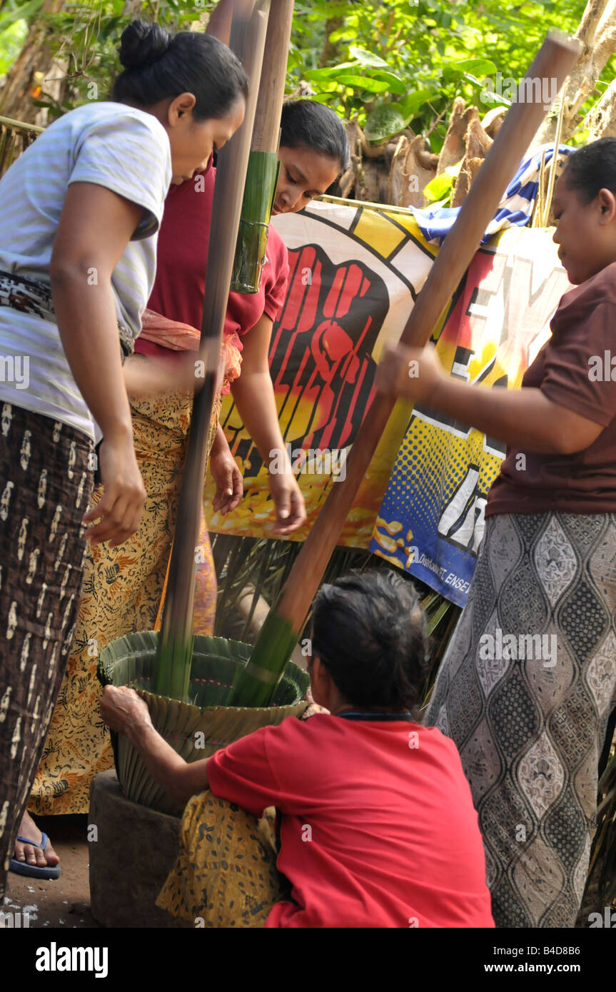 Woman pounding rice hi-res stock photography and images - Alamy