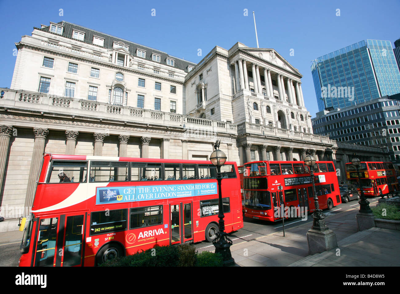 Typical red London double decker busses outside the Bank of England ...