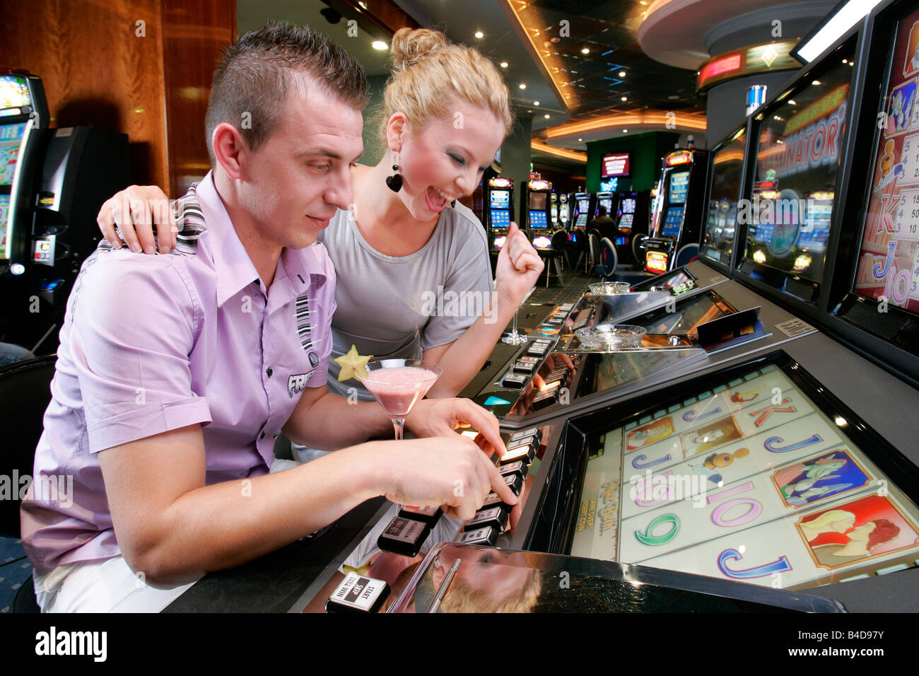 Girl playing fruit machine hi-res stock photography and images - Alamy