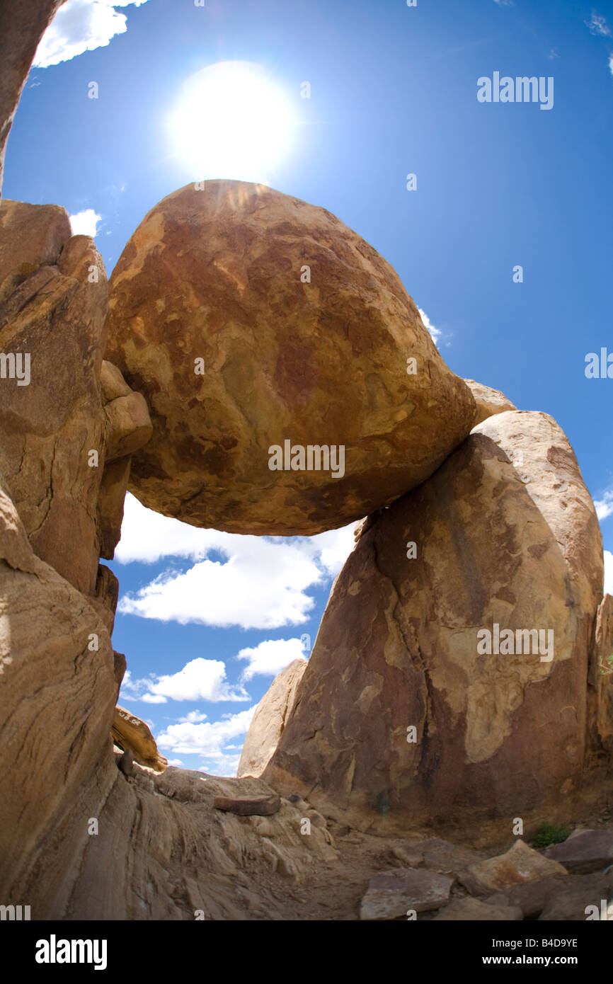 Wide angle shot of Balanced Rock with sun and blue sky in background ...