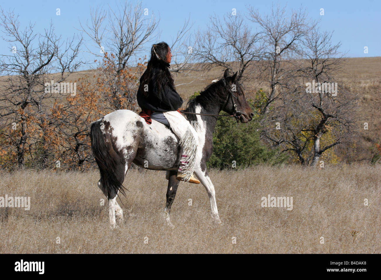 A Native American Lakota Sioux Indian Riding Horseback On The Prairie