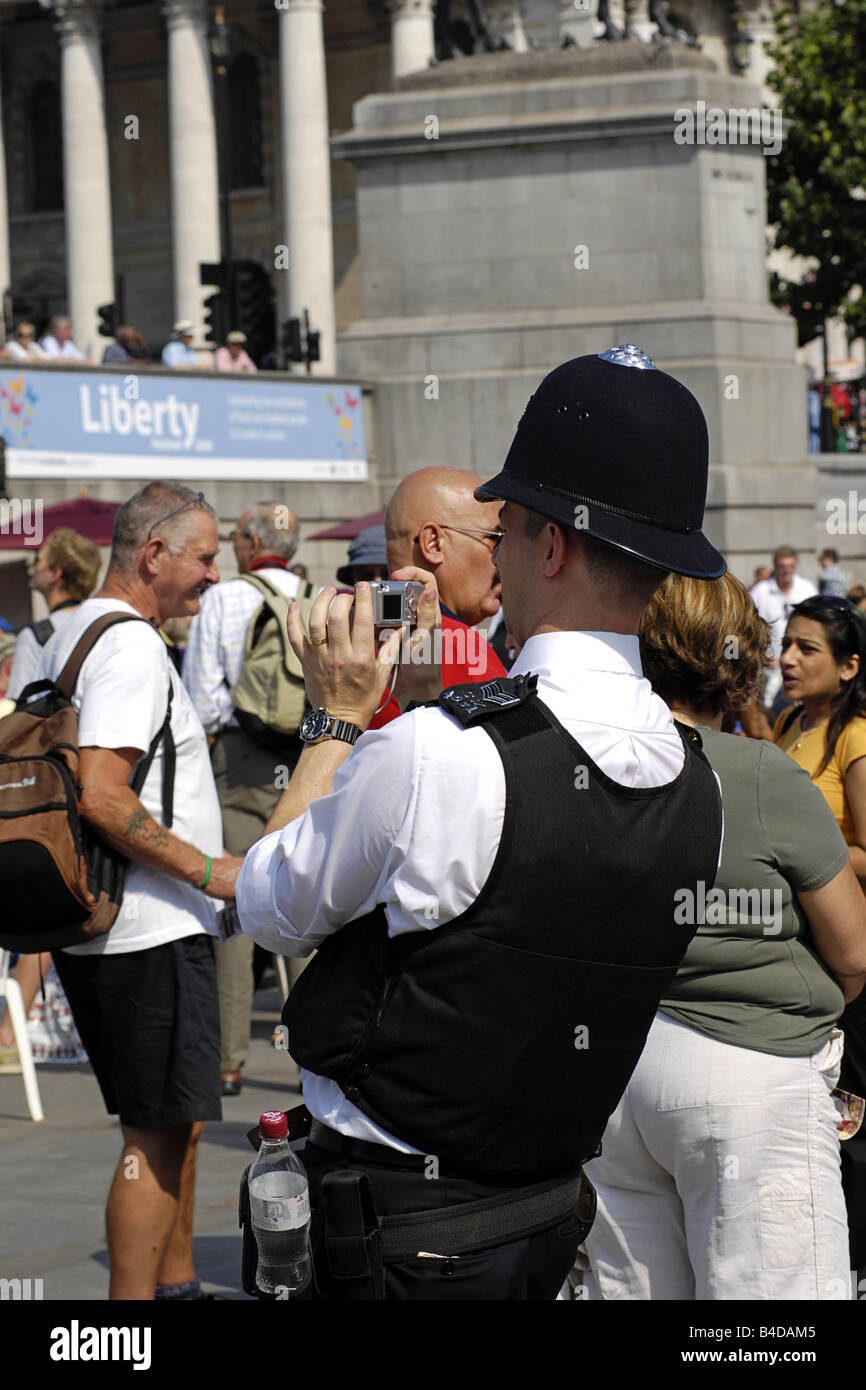 London Police Officer using a small digital camera to possibly ...