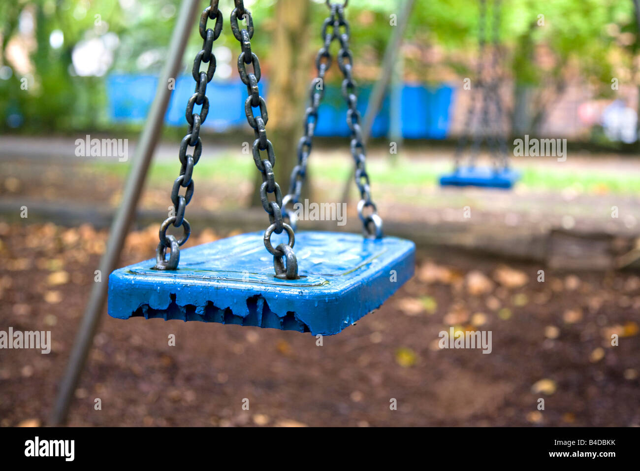 Blue empty swing Stock Photo - Alamy