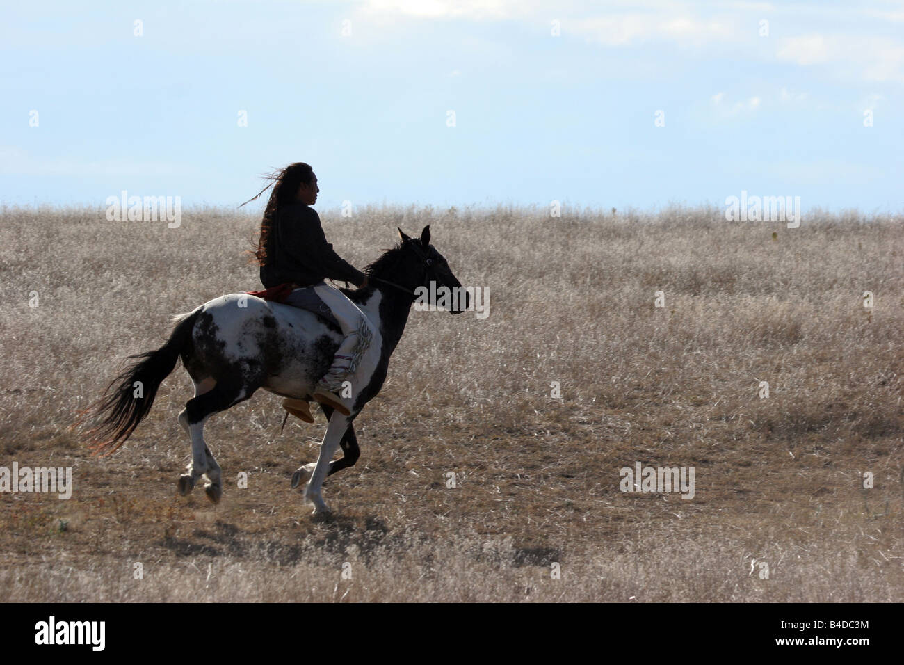 A Native American Lakota Sioux Indian riding horseback on the prairie ...