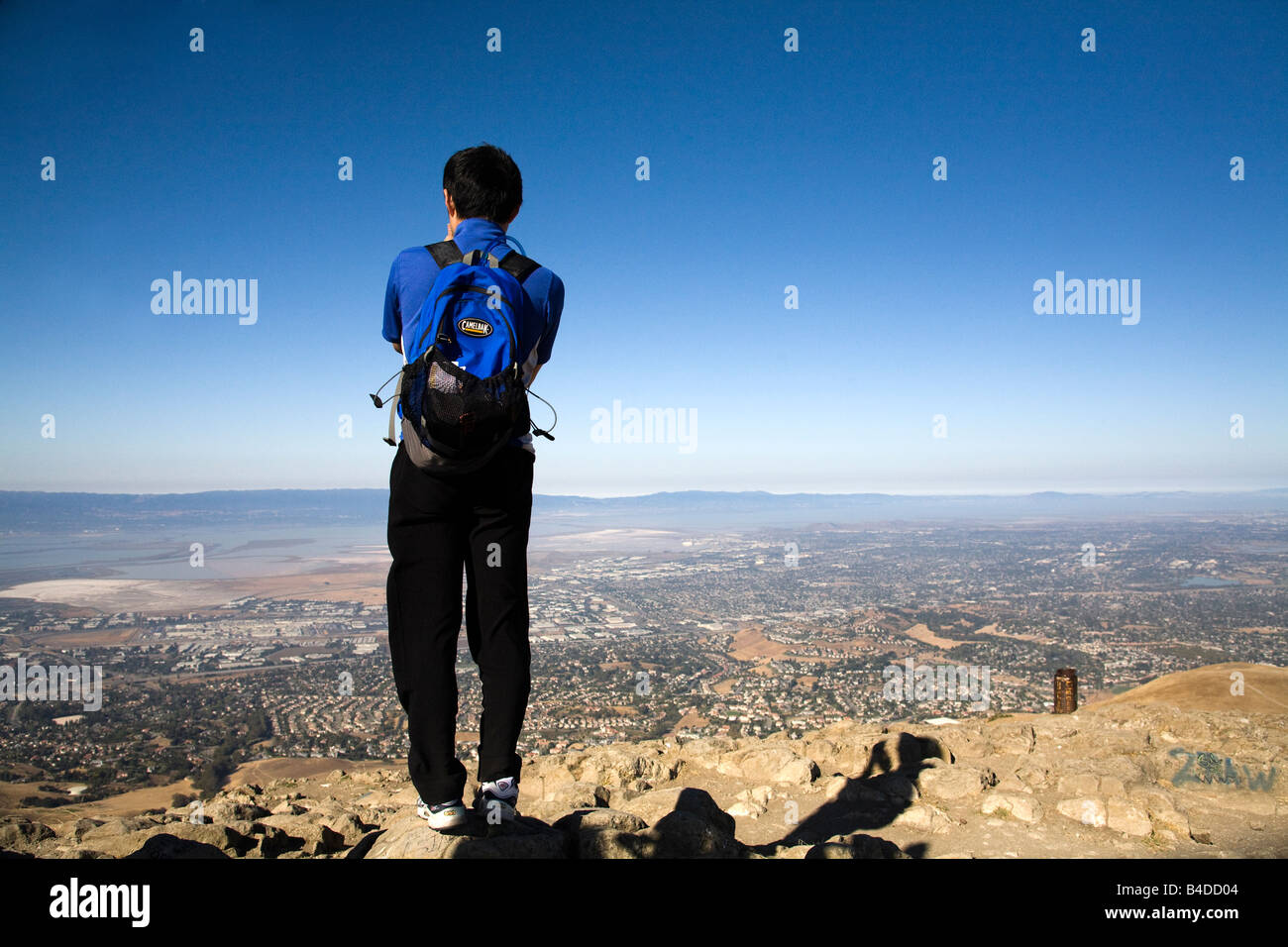 After reaching the summit of Mission Peak a hiker takes in the view of ...