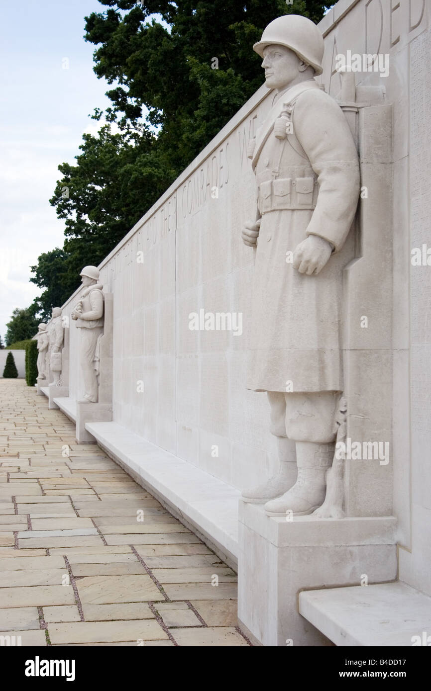 stone wall and carved soldiers the American Cemetery Memorial grounds ...