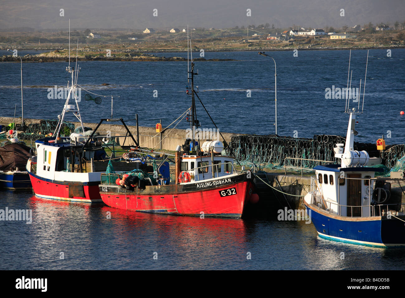 fishing boats in the harbour of Roundstone in the evening light ...