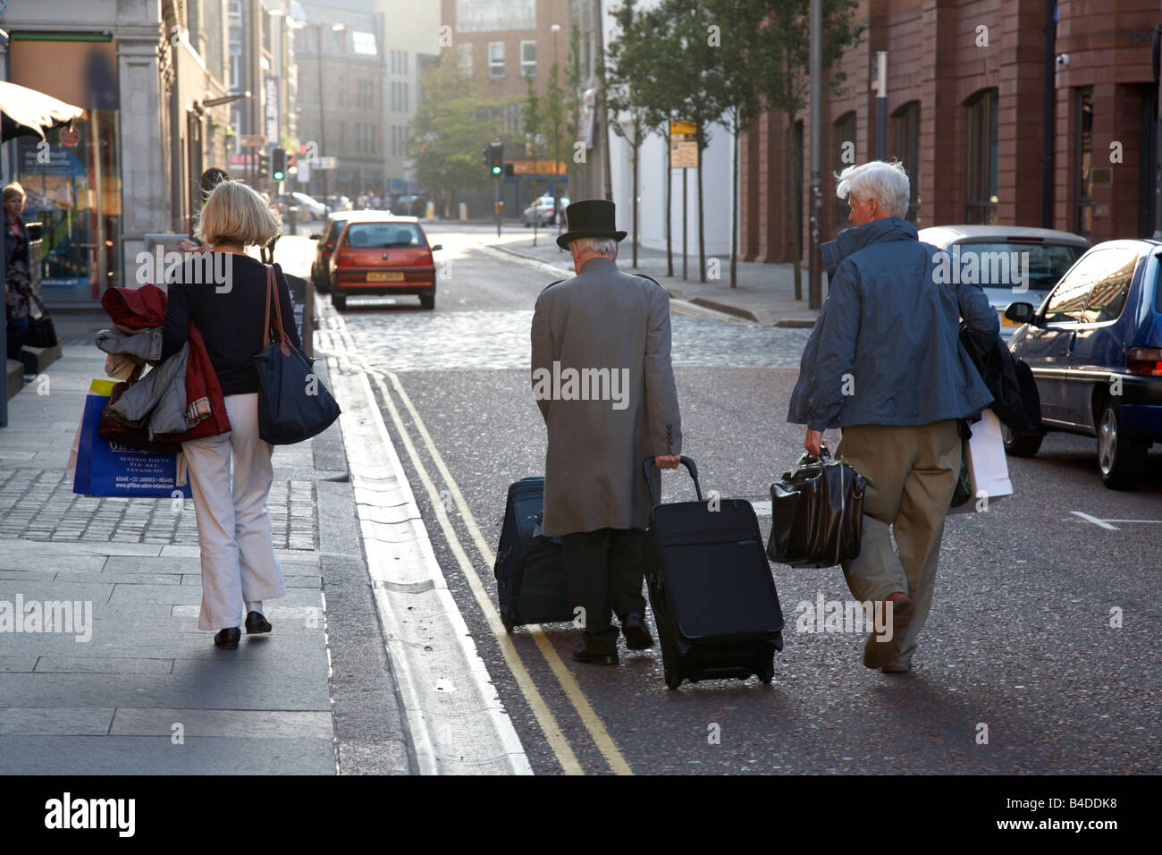 hotel concierge with guests luggage leading guest down a street Stock ...