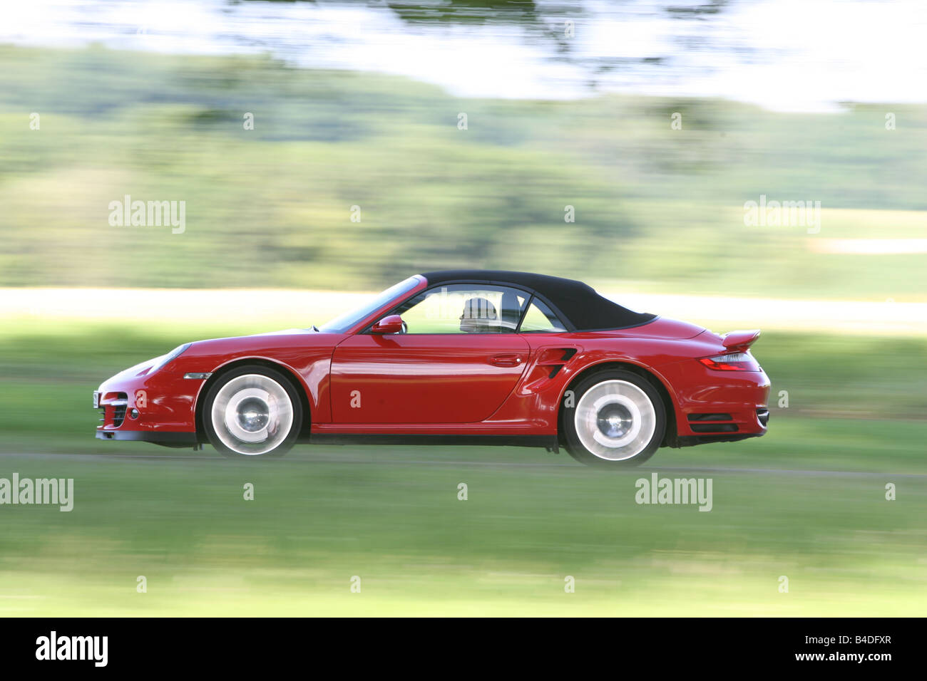 Porsche 911 Turbo Convertible, model year 2007-, red, driving, side ...