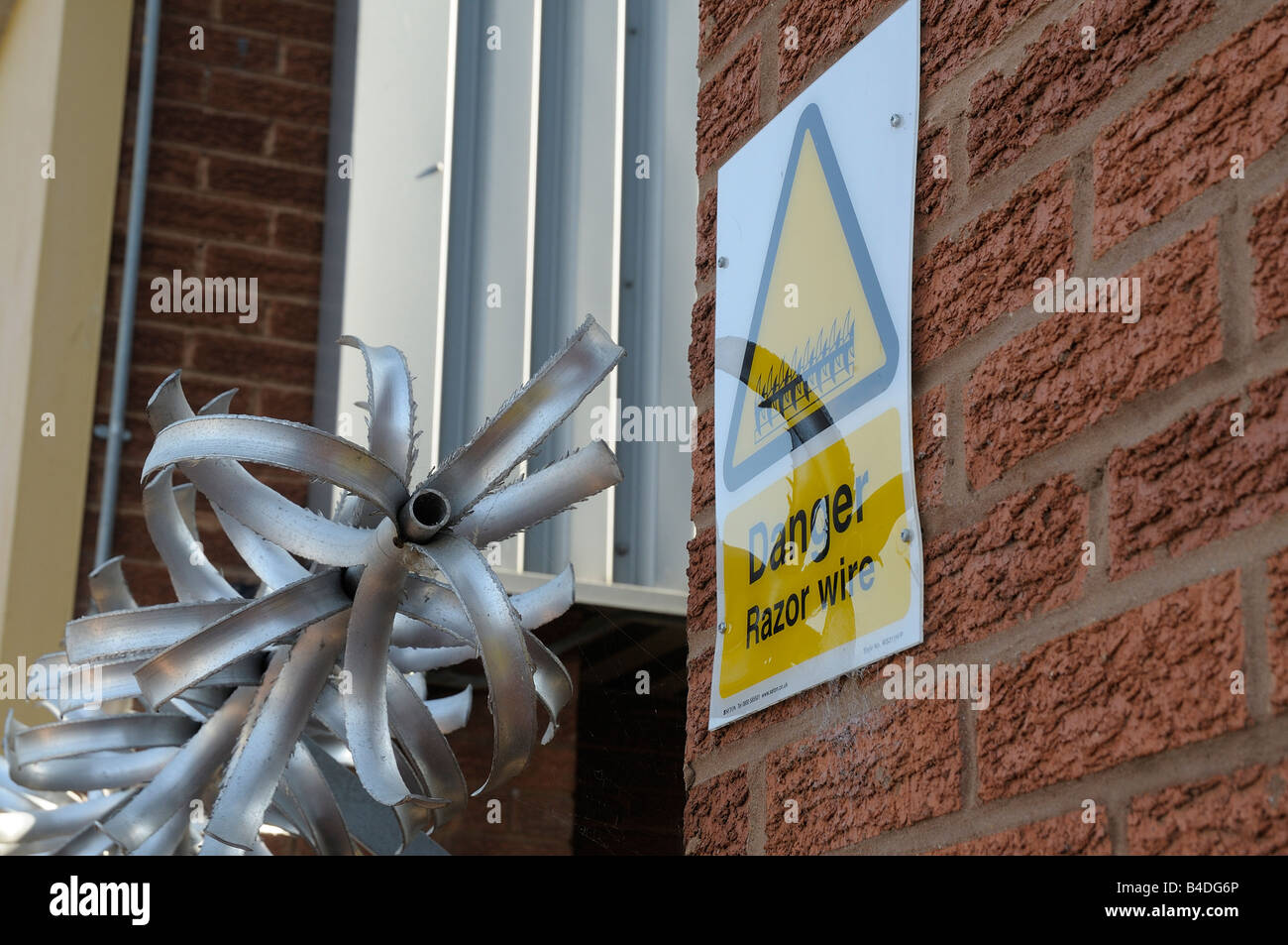 Razor wire and warning sign. Landscape Stock Photo - Alamy