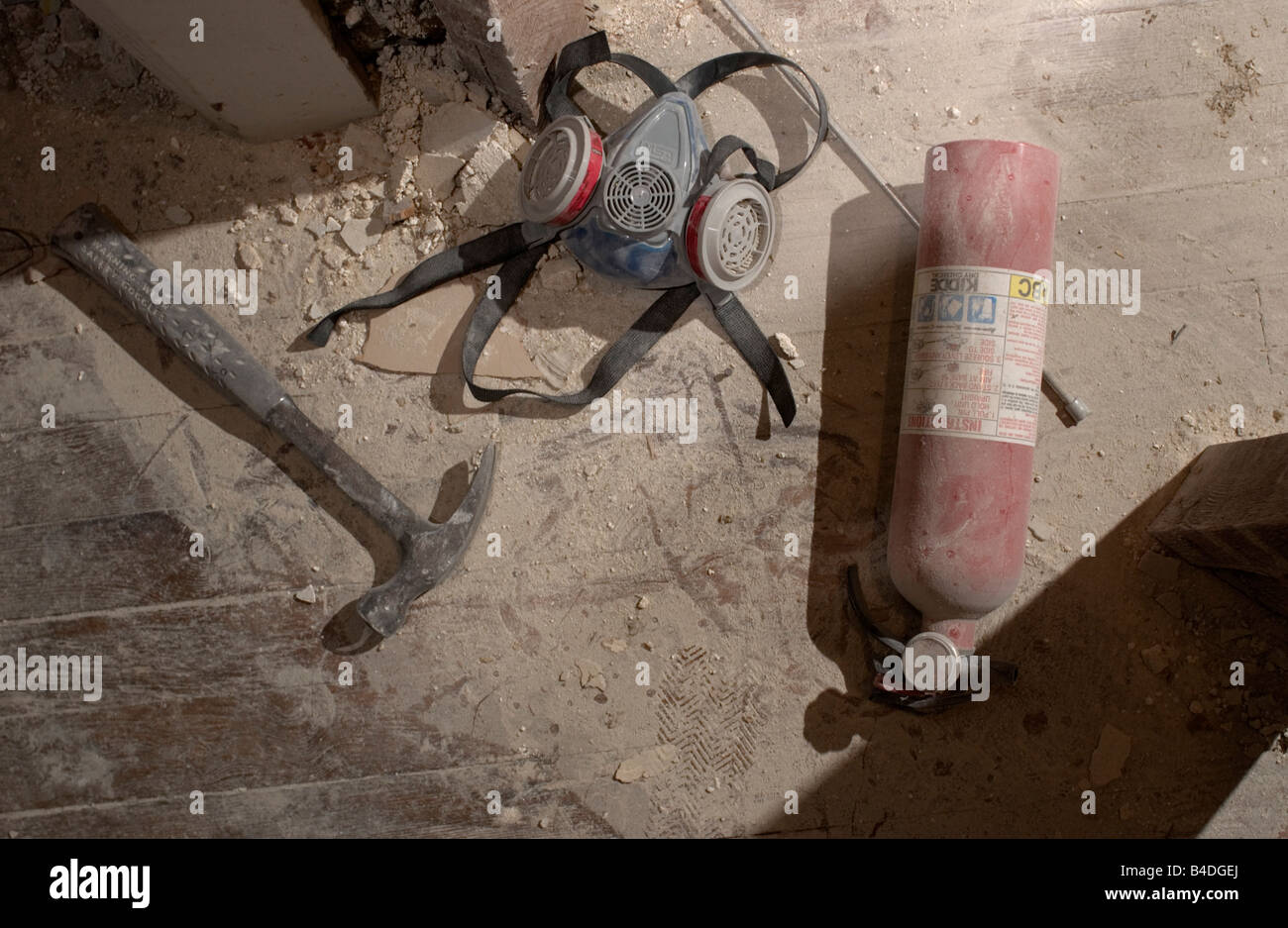 Hammer, dust mask, and fire extinguisher covered in plaster Stock Photo ...