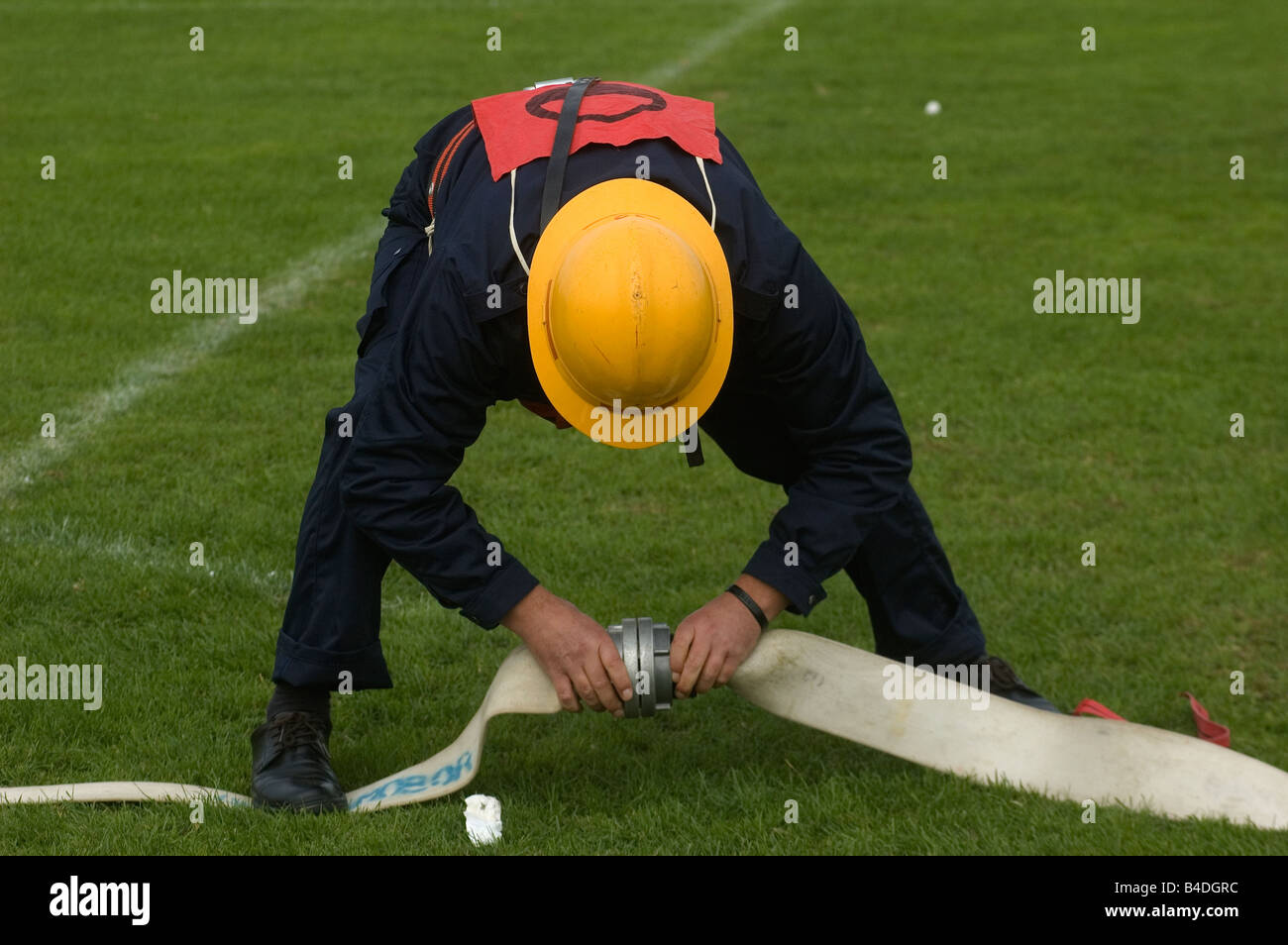 Fireman with fire hose Stock Photo - Alamy