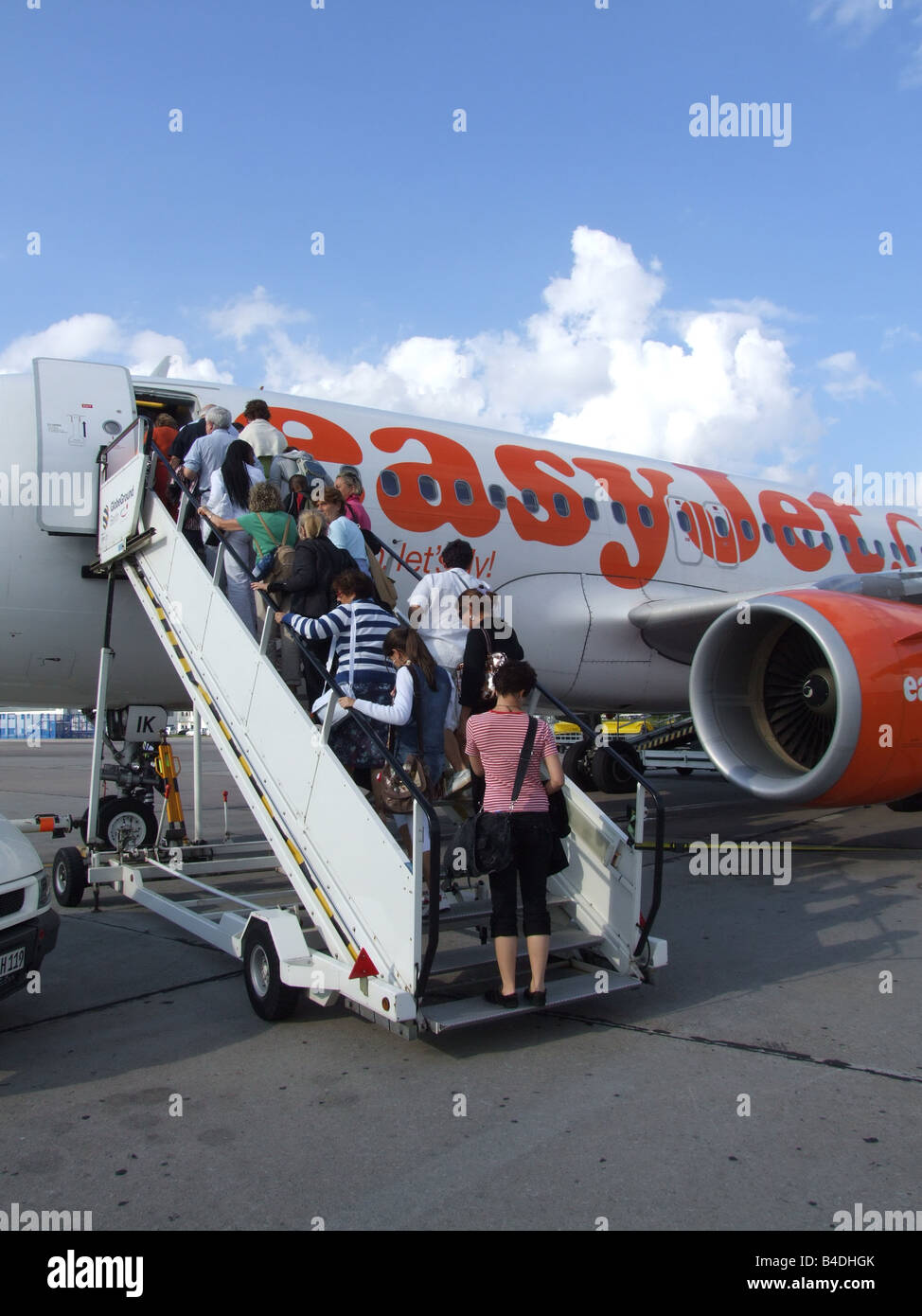 passengers in queue getting on easy jet plane Stock Photo - Alamy
