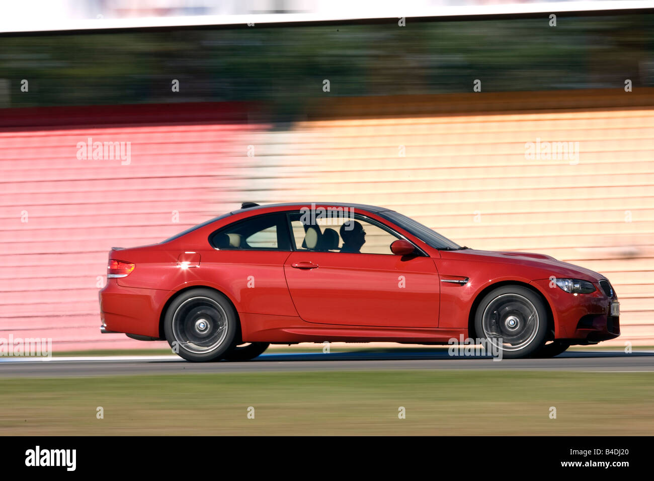 BMW M3 Coupe, model year 2007-, red, driving, side view, test track ...