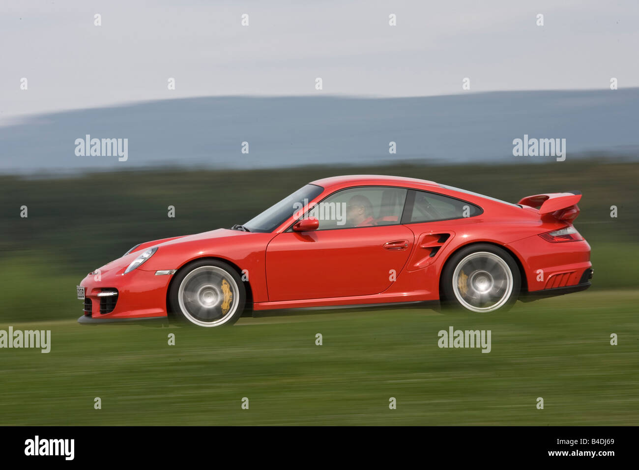 Porsche 911 GT2, model year 2007-, red, driving, side view, country ...
