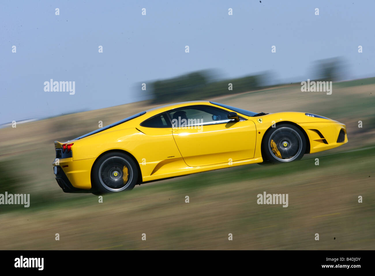 Ferrari 430 Scuderia, model year 2007-, yellow, driving, side view ...