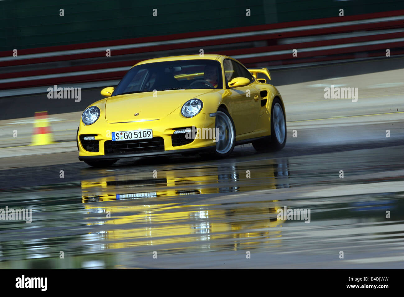 Porsche 911 GT2, model year 2007-, yellow, driving, diagonal from the ...