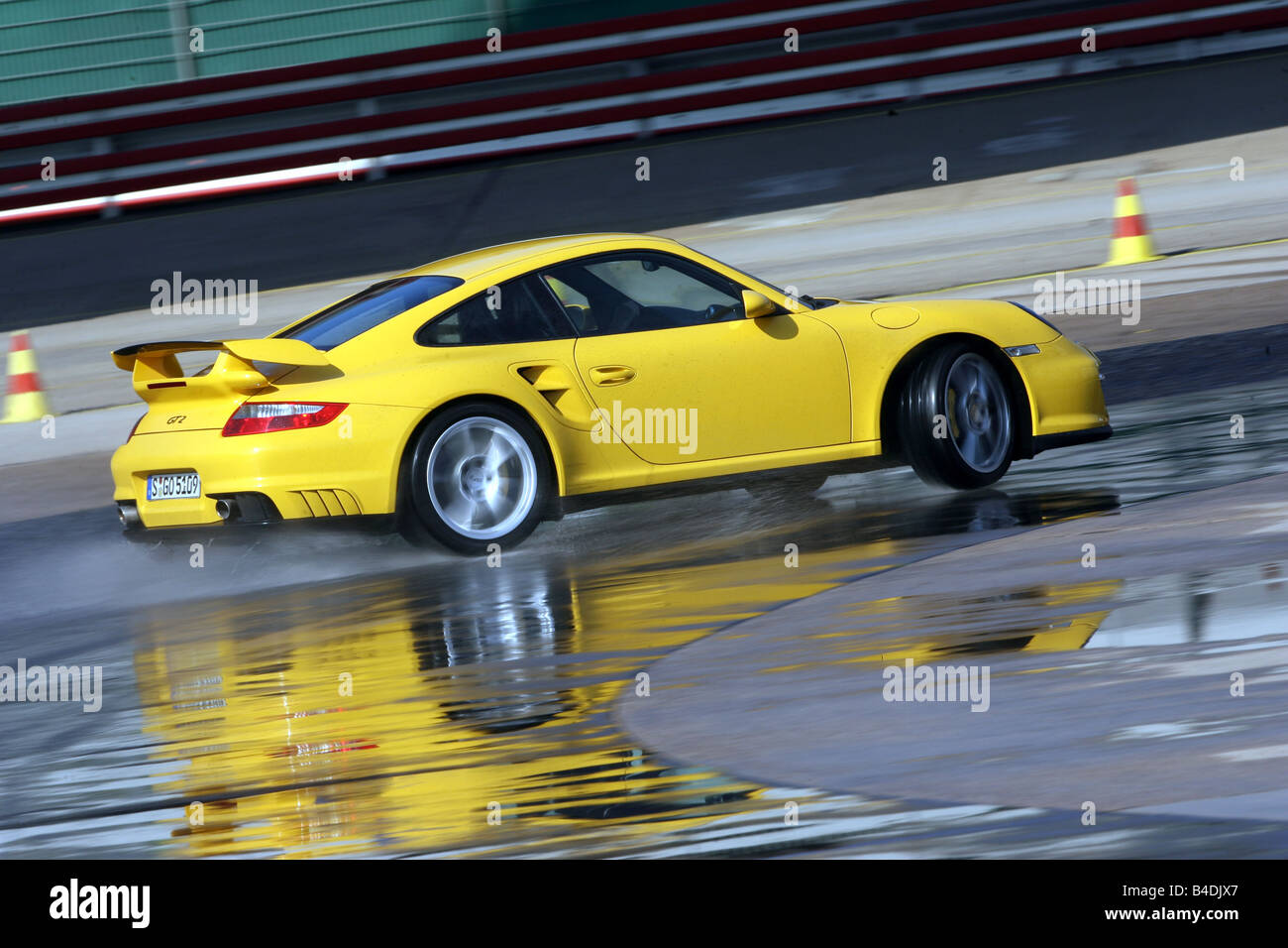 Porsche 911 GT2, model year 2007-, yellow, driving, diagonal from the ...
