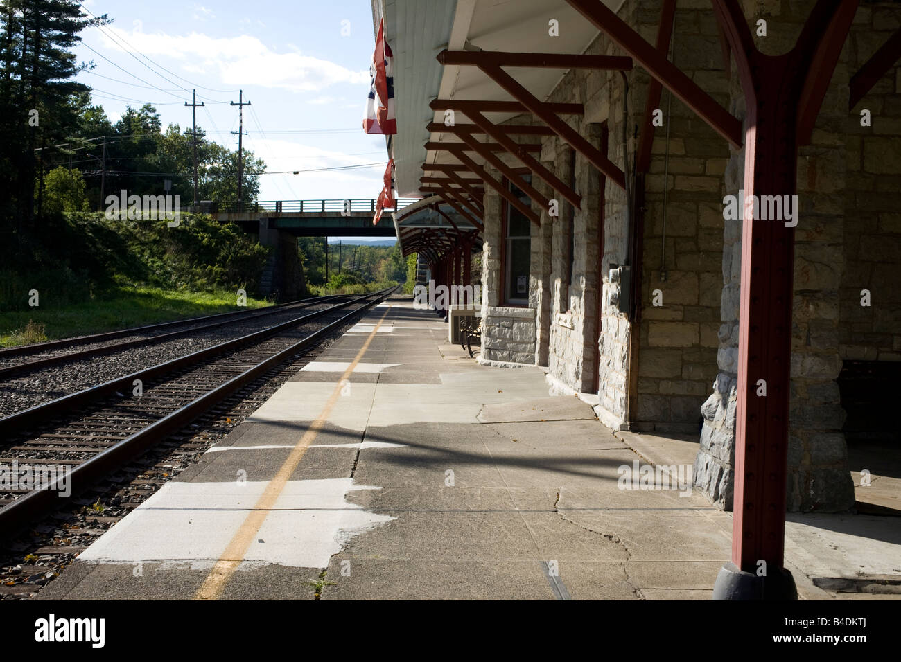 A lonely railroad station with bunting hanging on scenic railroad line ...