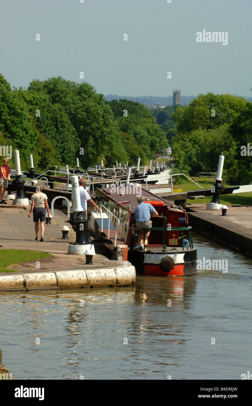Boat negotiating the flight of locks at Hatton Warwickshire with St ...