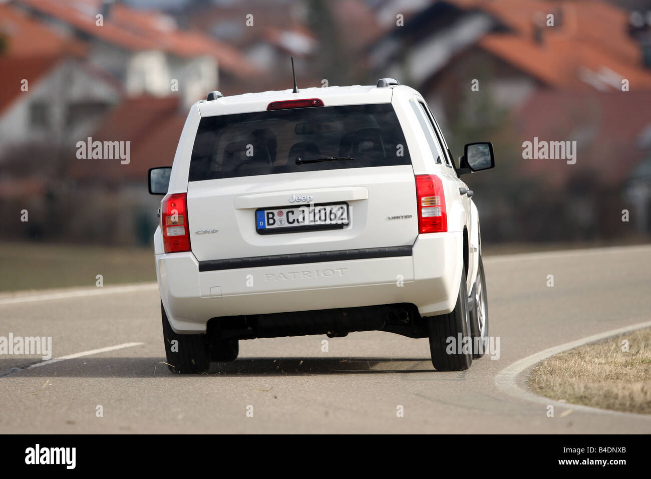 Jeep Patriot, model year 2008-, white, driving, diagonal from the back ...