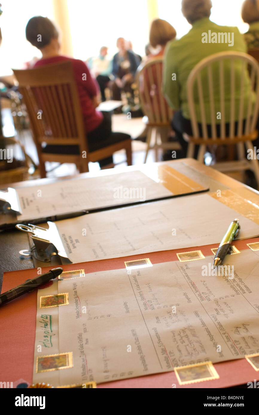 Women gather for a meeting with sign up sheet in forground Stock Photo ...