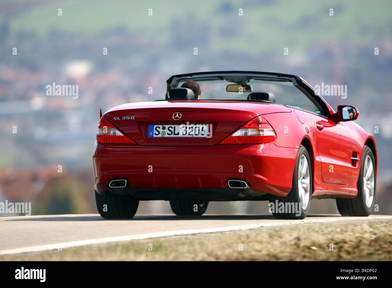 Mercedes SL 350, model year 2008-, red, driving, diagonal from the back ...