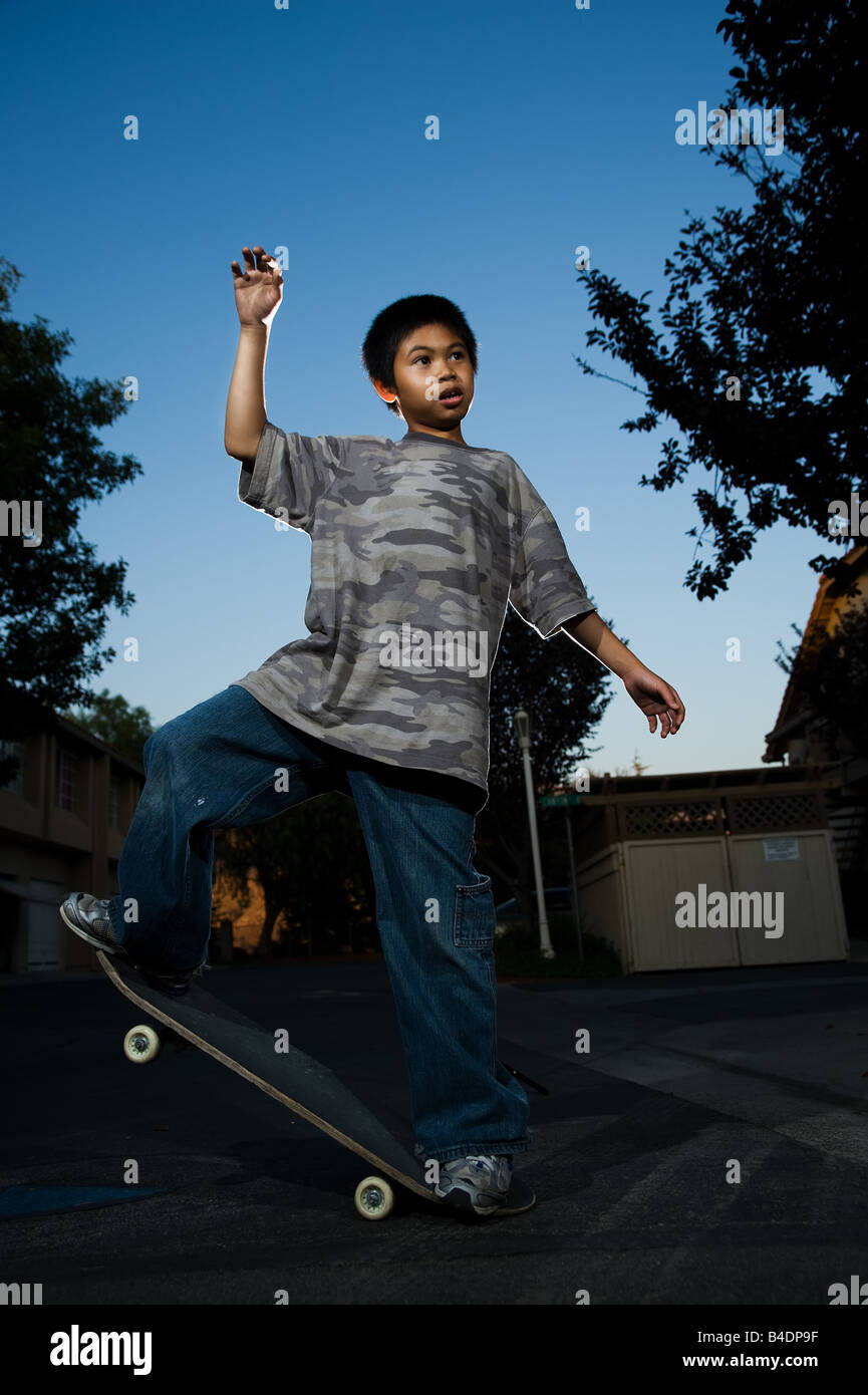 Balancing on a skateboard Stock Photo - Alamy