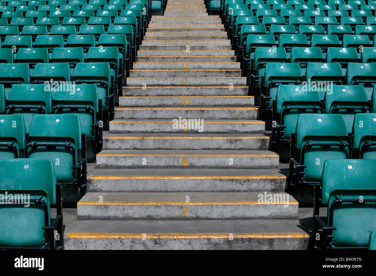 Numbered steps in a sports stadium in between the green pastic seating ...