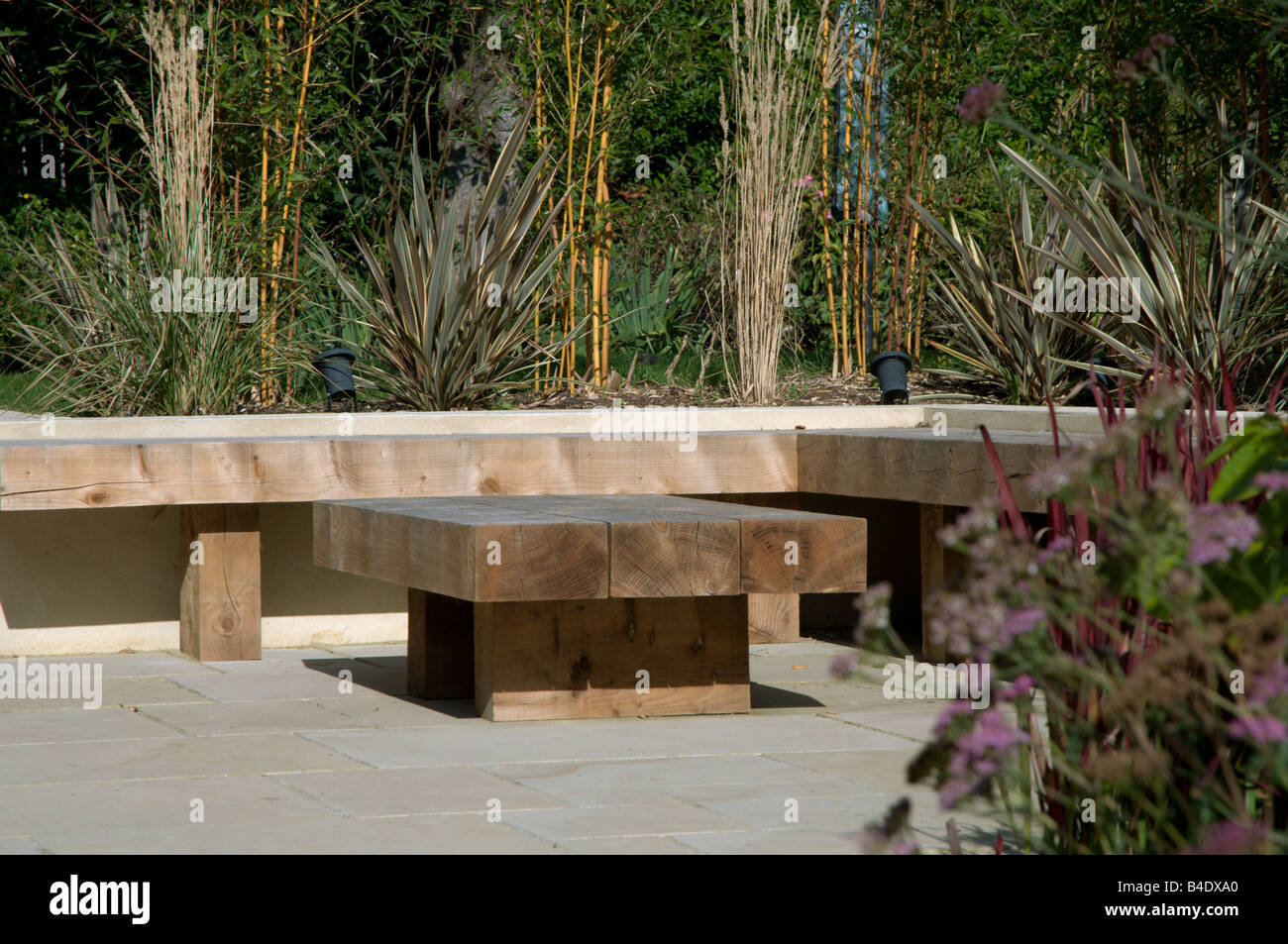 wooden seating in modern paved garden Stock Photo - Alamy