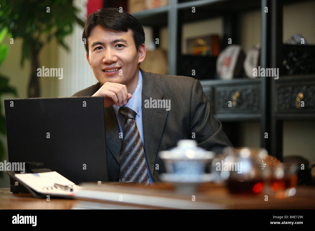 Chinese Business Man Using The Notebook PC Stock Photo - Alamy