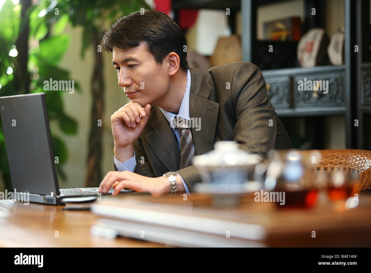 Chinese Business Man Using The Notebook PC Stock Photo - Alamy