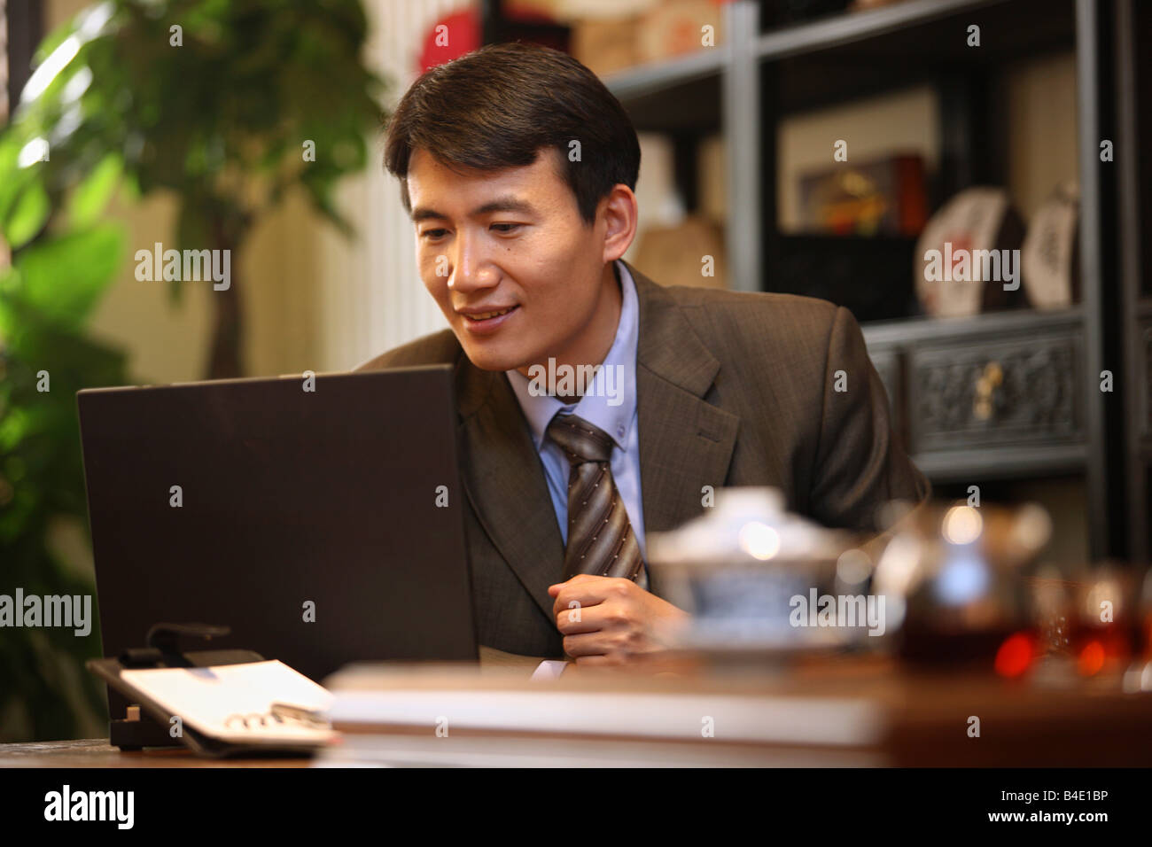 Chinese Business Man Using The Notebook PC Stock Photo - Alamy