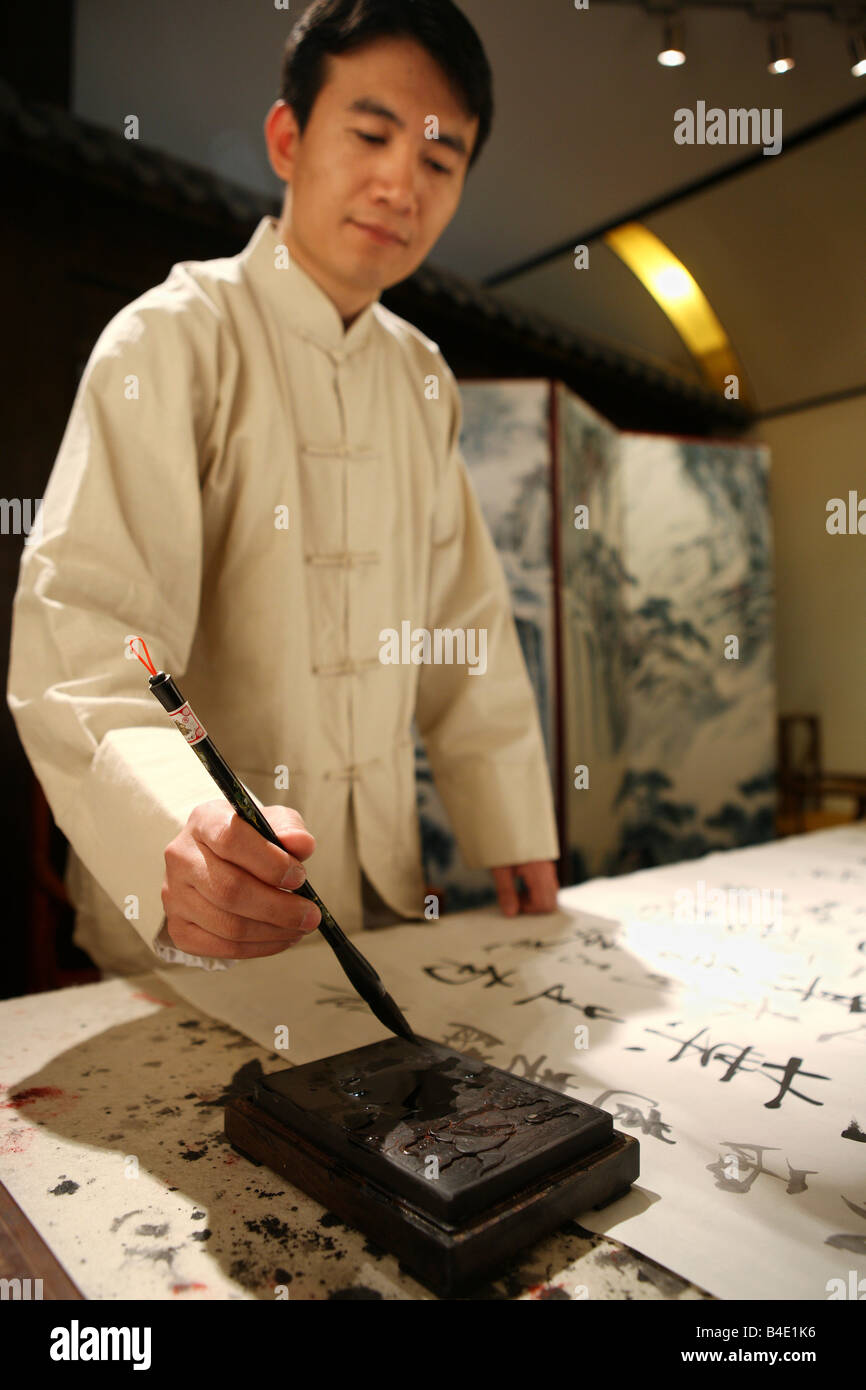 Chinese Man Practising Calligraphy Stock Photo - Alamy