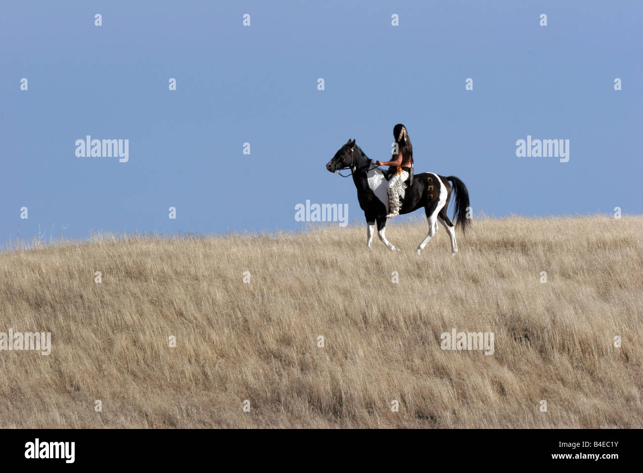 A Native American Lakota Sioux Indian riding horseback on the prairie ...