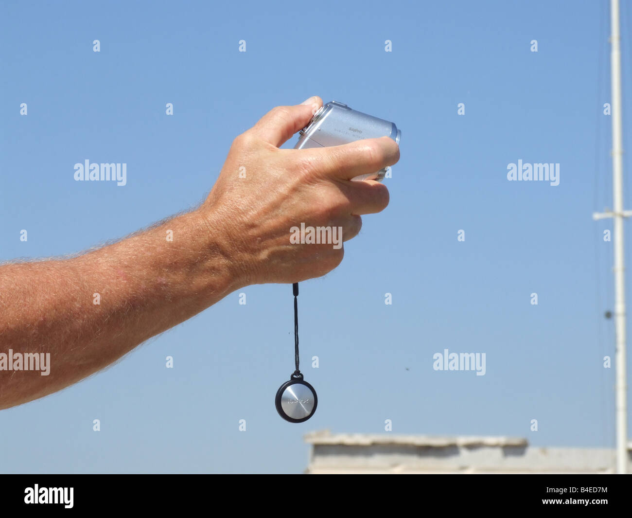 person using small video camera outside in sun Stock Photo - Alamy