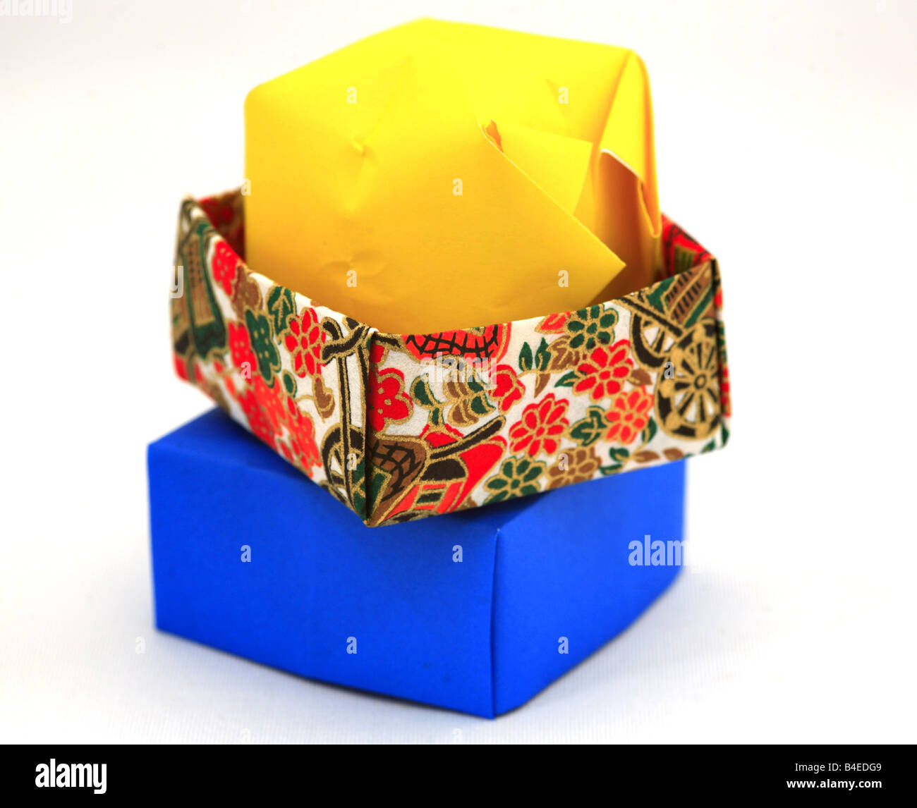 Part 1 of 2 pictures, close-up of a stack of colorful origami boxes and ...