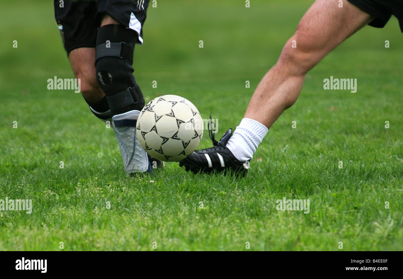 Two men playing soccer Stock Photo - Alamy