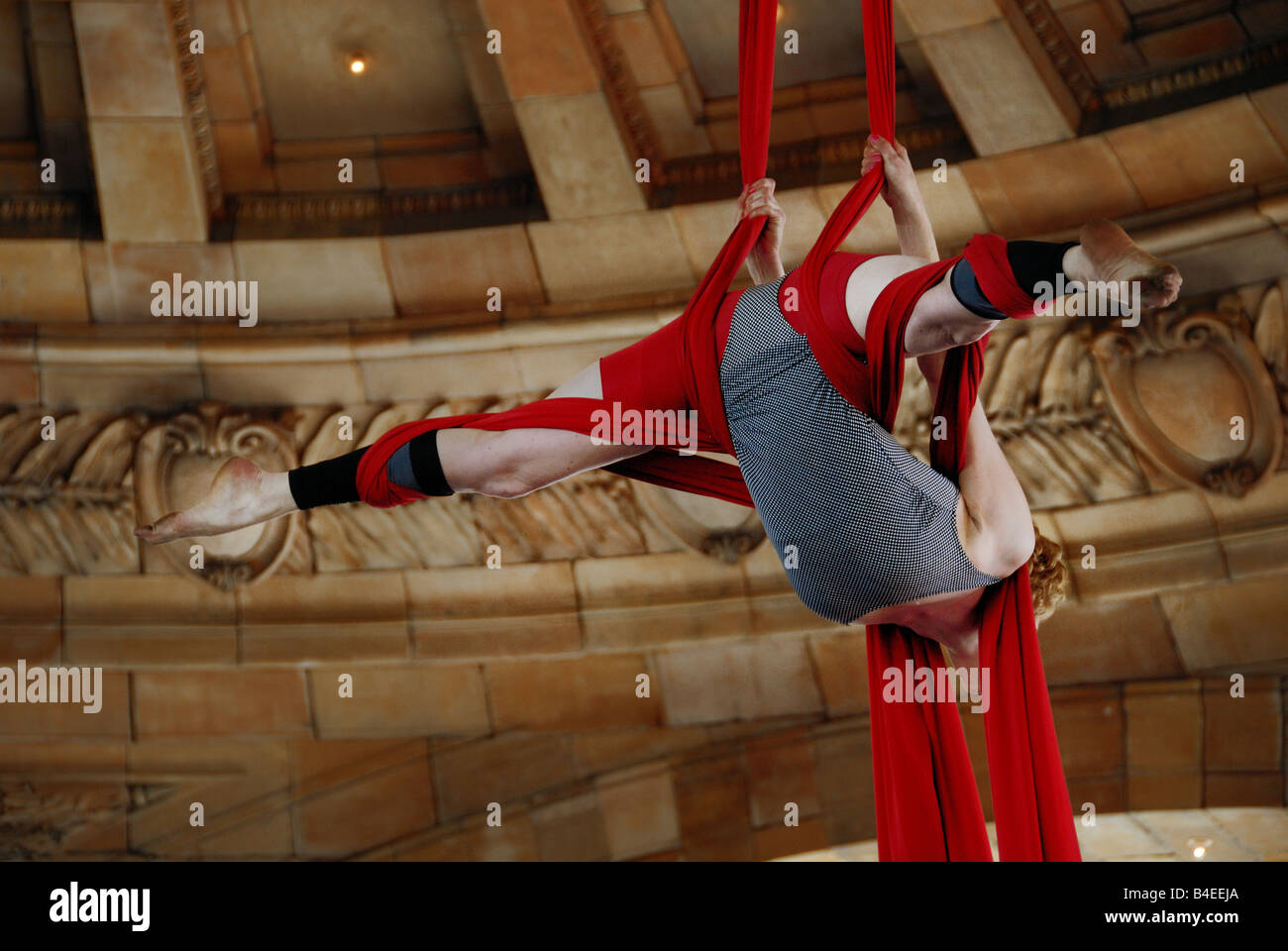 This aerial ribbon drape performer exhibits ballet like poses high in ...