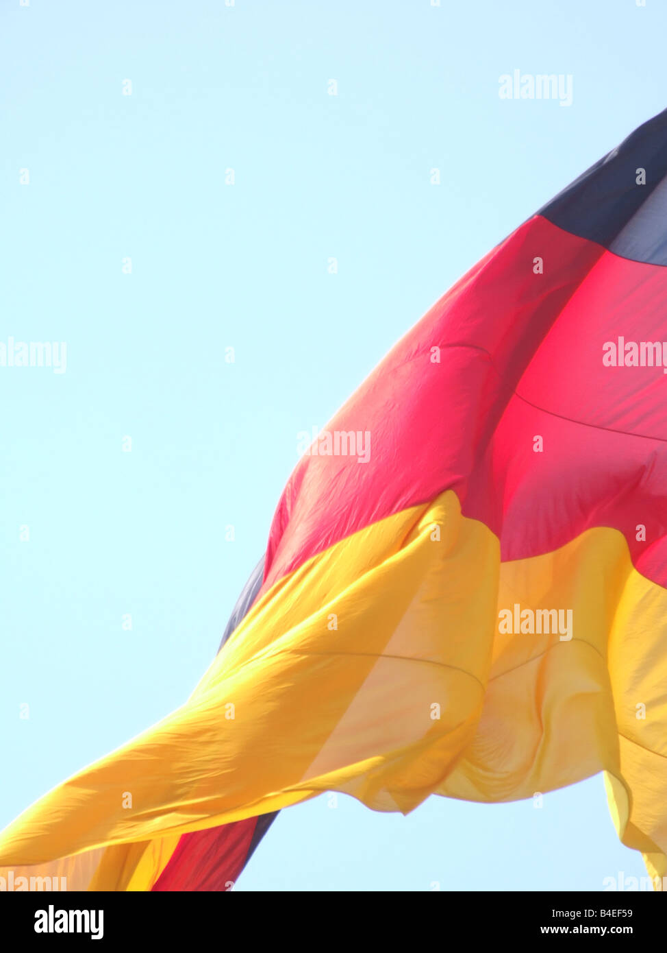 german flag flying in blue sky in berlin Stock Photo - Alamy