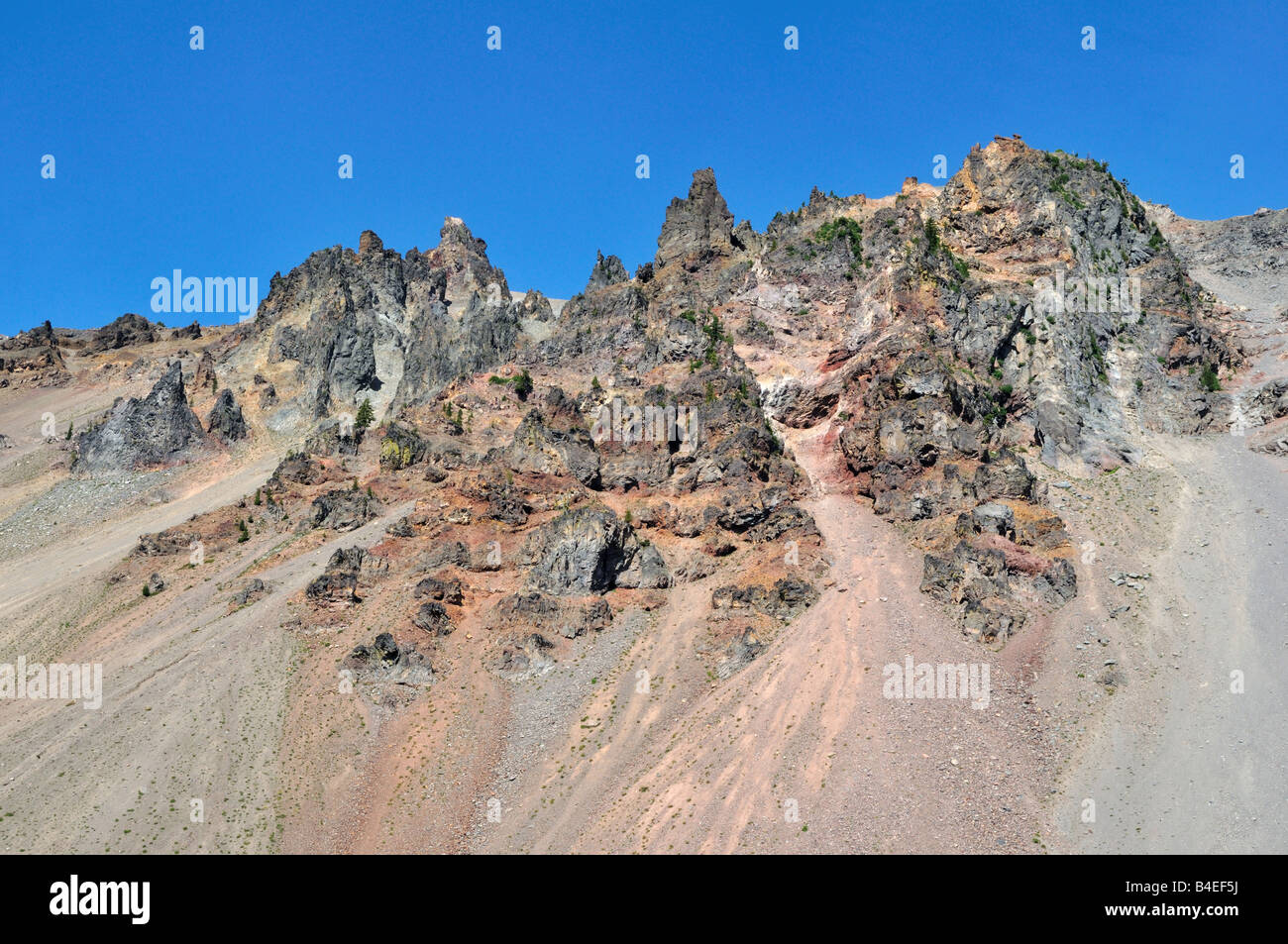 Colorful volcanic rocks around the rim of the Crater Lake. The Crater ...