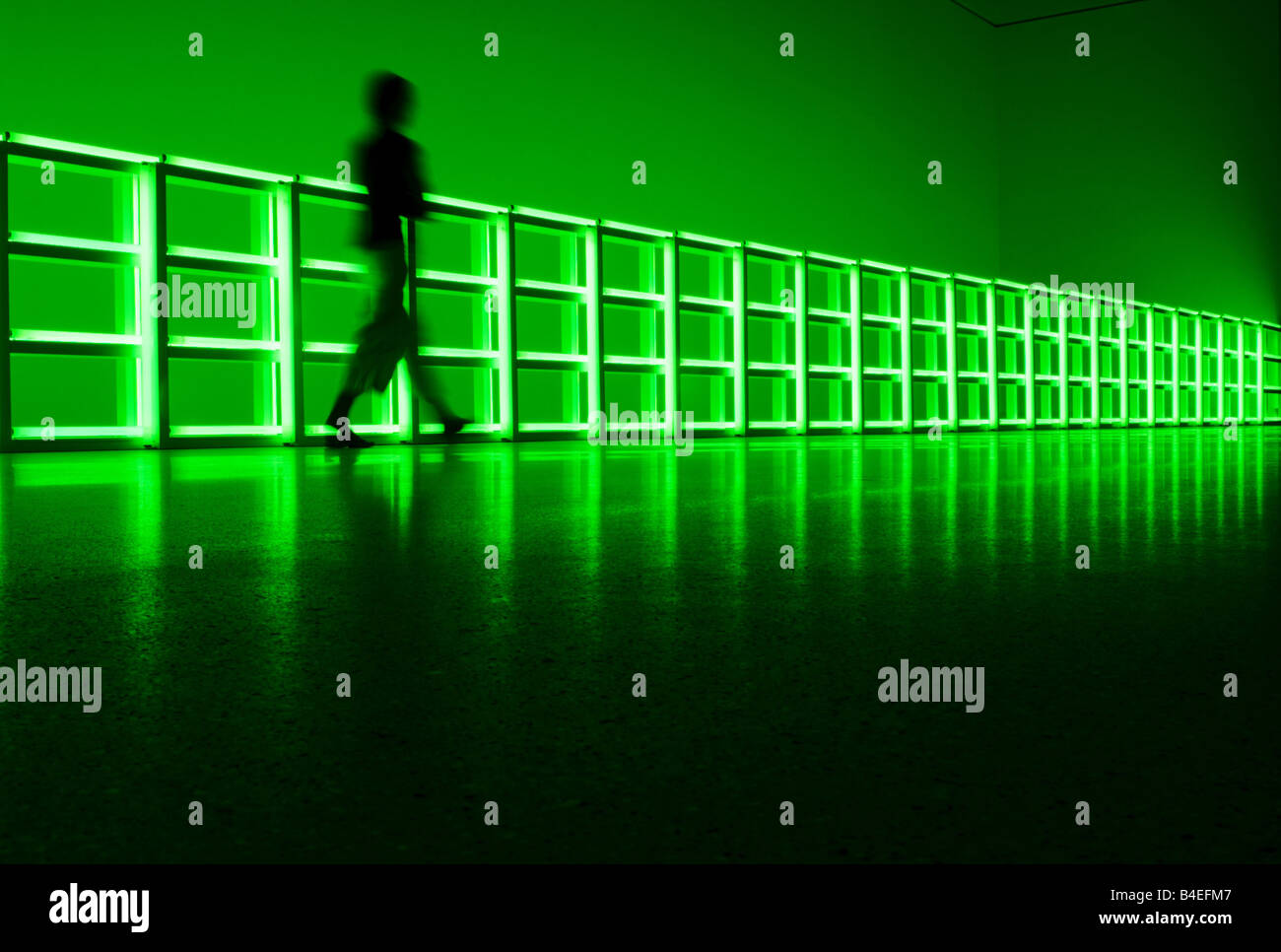 Girl walking through a modern art exhibition in a museum in Germany ...